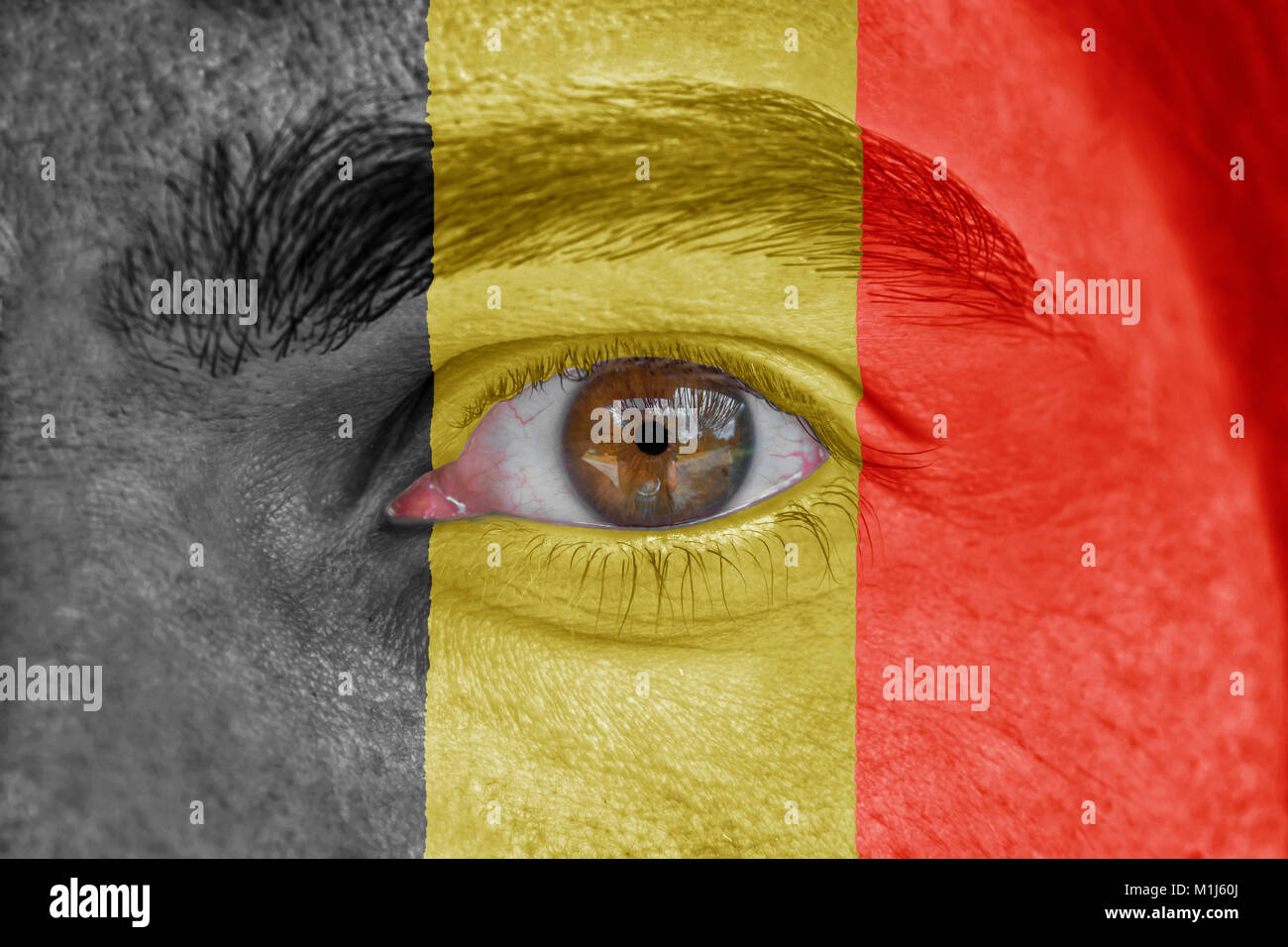 Human face and eye painted with flag of Belgium Stock Photo - Alamy