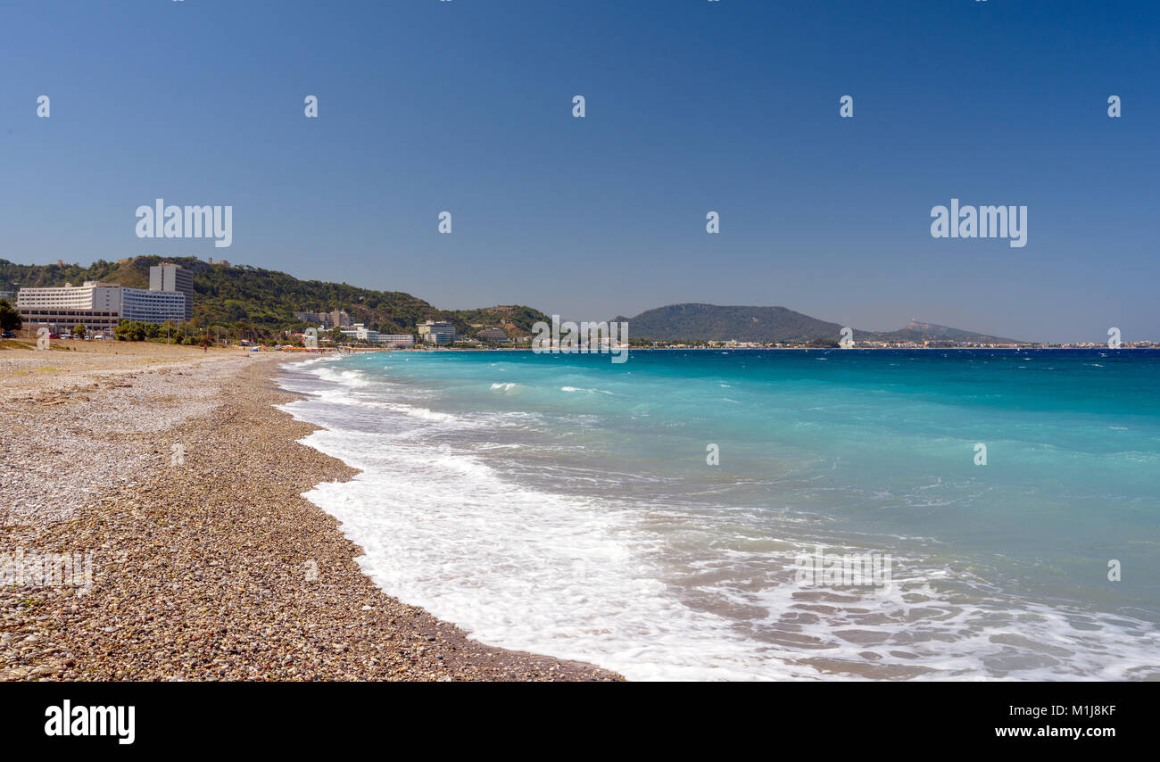 Pebble beach with clear blue water on Rhodes island, Greece Stock Photo ...
