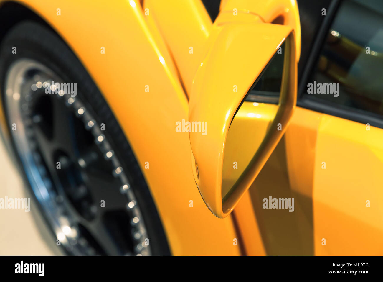 Luxury yellow sports car mirror, close up photo. Italian car design ...