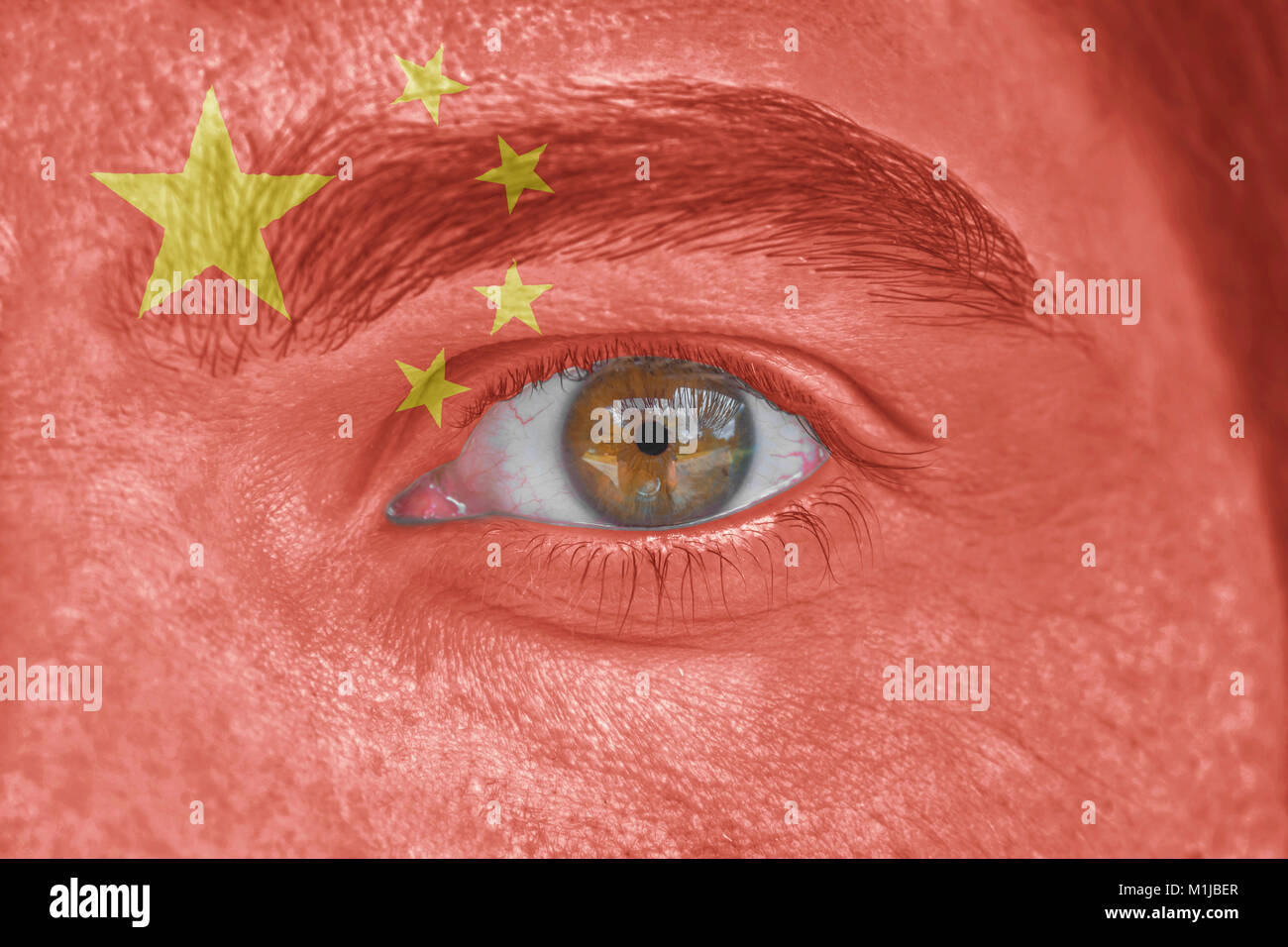 Human face and eye painted with flag of China Stock Photo - Alamy