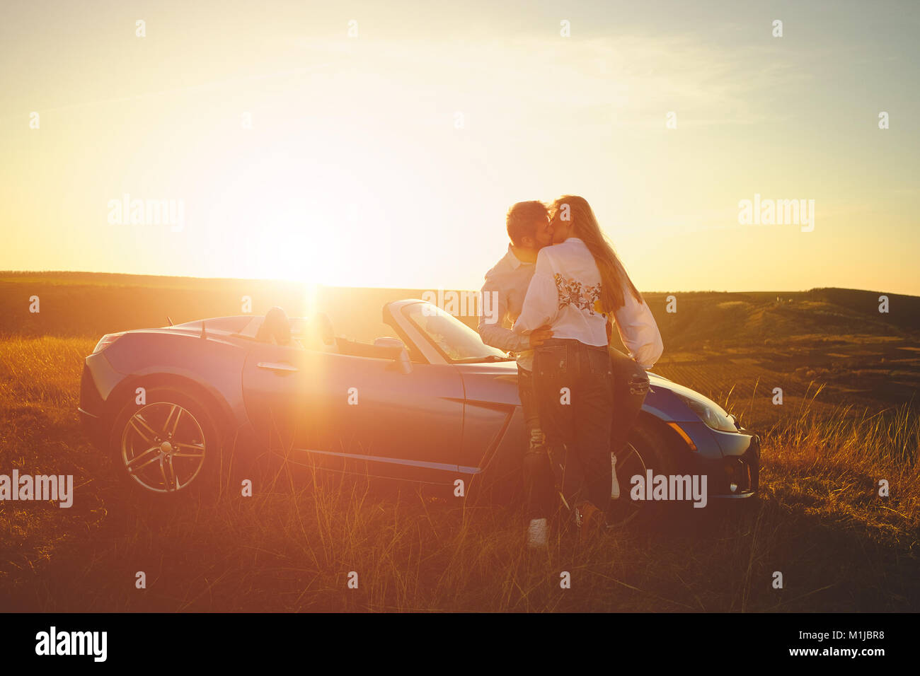 Couple kissing and hugging Stock Photo - Alamy