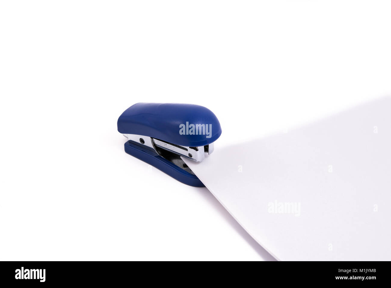 Small blue stapler with paper on white background Stock Photo - Alamy