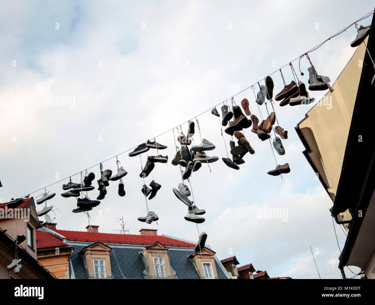 Old trainers hanging by laces hi-res stock photography and images - Alamy