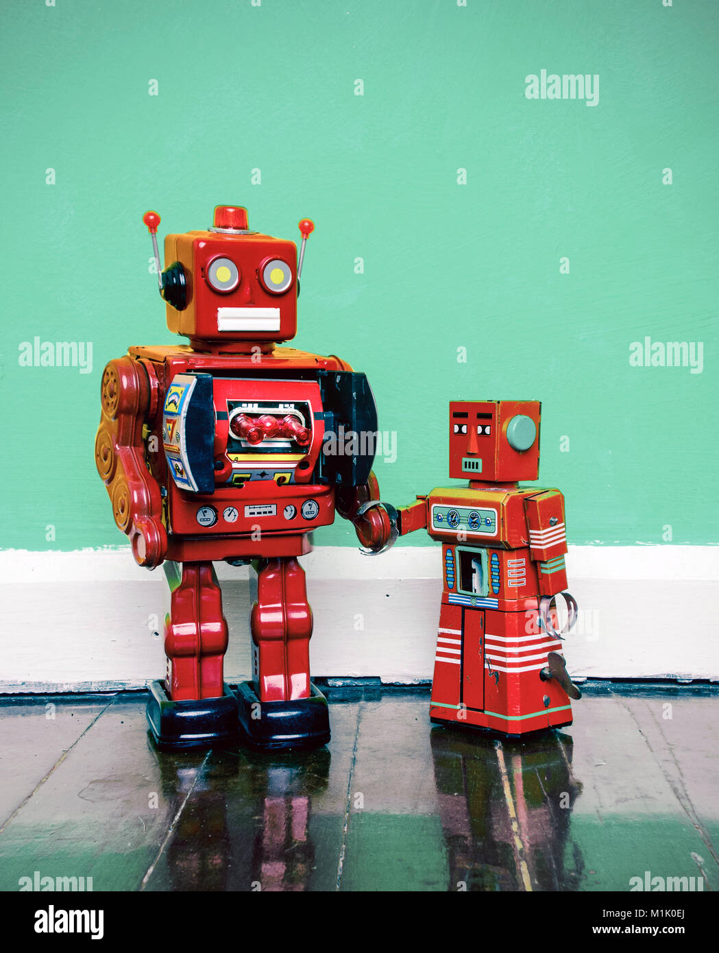 robot toy family father and son with a green background Stock Photo - Alamy