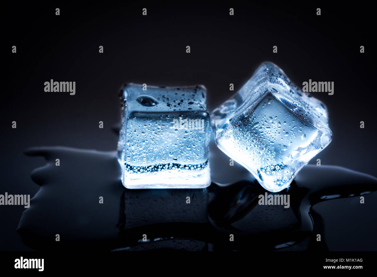 Two ice cubes on black reflection background Stock Photo - Alamy