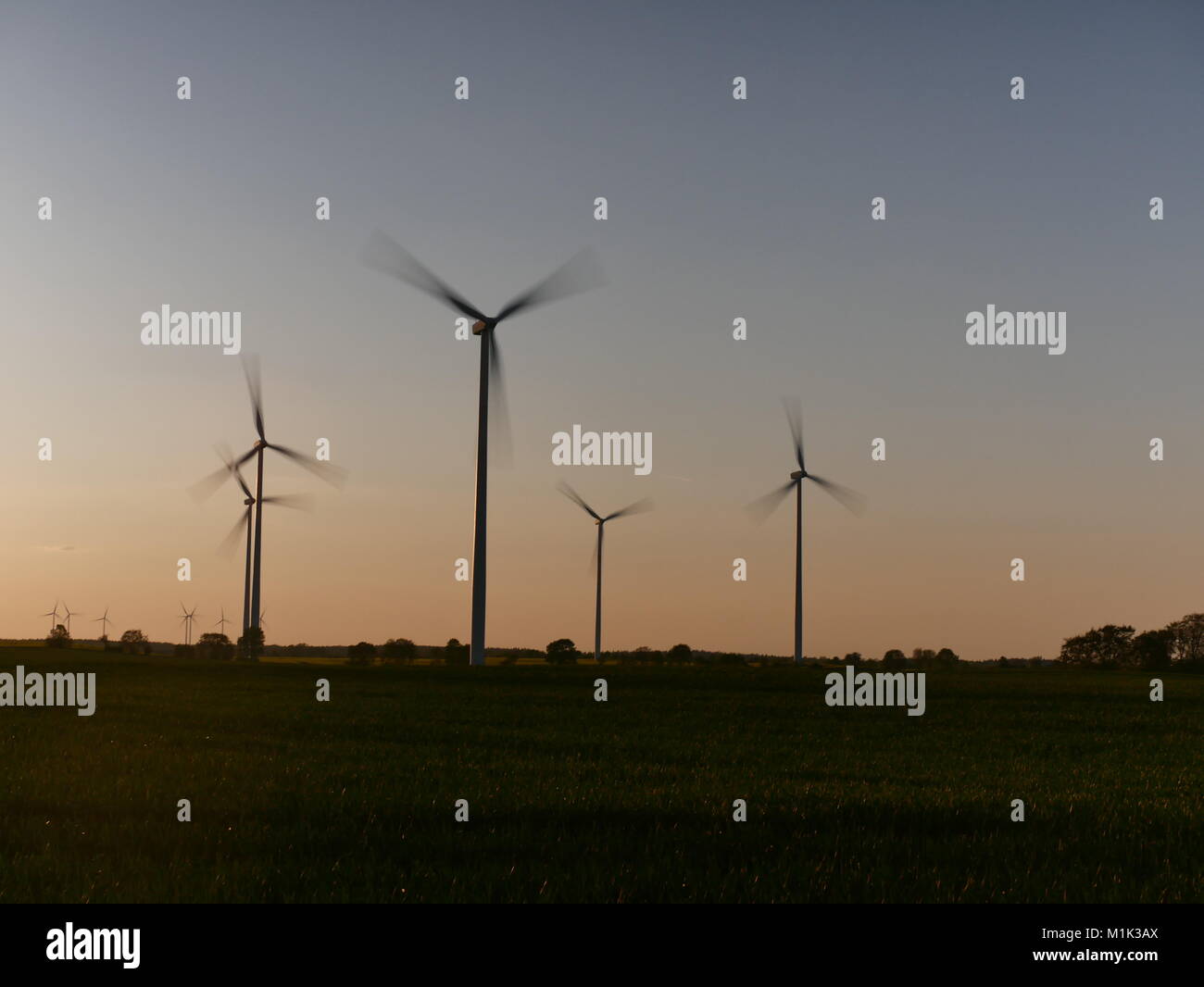 wind turbine on sunset background Stock Photo - Alamy