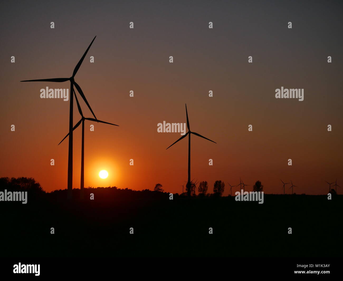 wind turbine on sunset background Stock Photo - Alamy