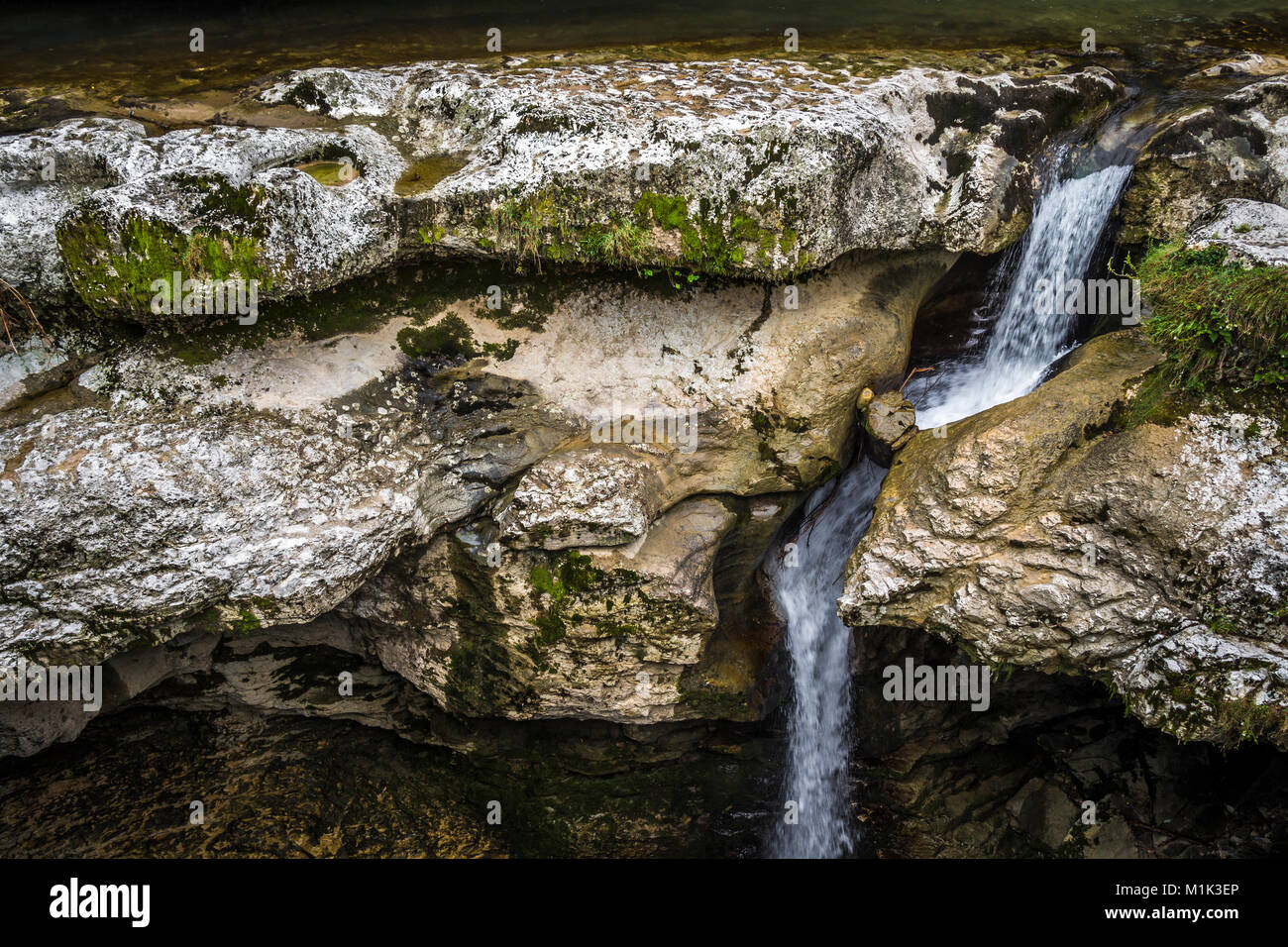 Beautiful small waterfall in wild overgrown places Stock Photo - Alamy