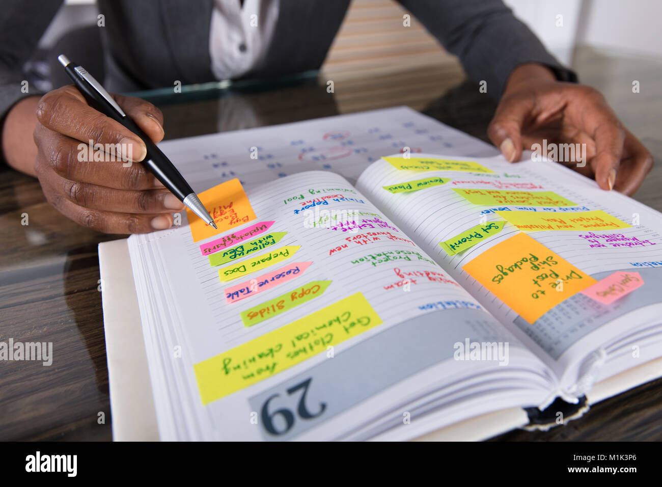 Businesswoman Looking At List Of Business Work In Diary With Calendar ...