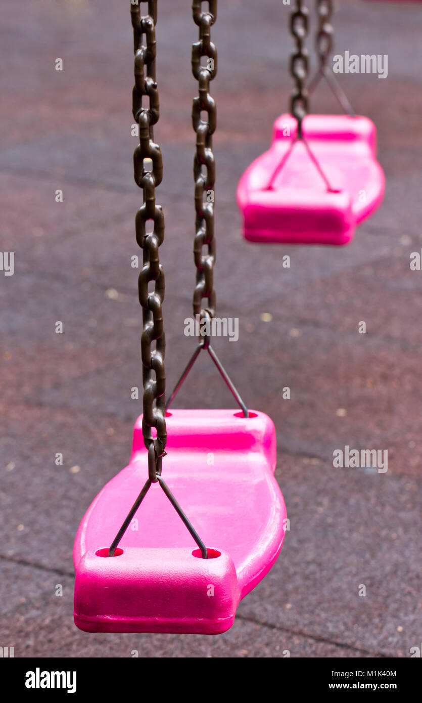 Close up of pink swing in playground Stock Photo - Alamy