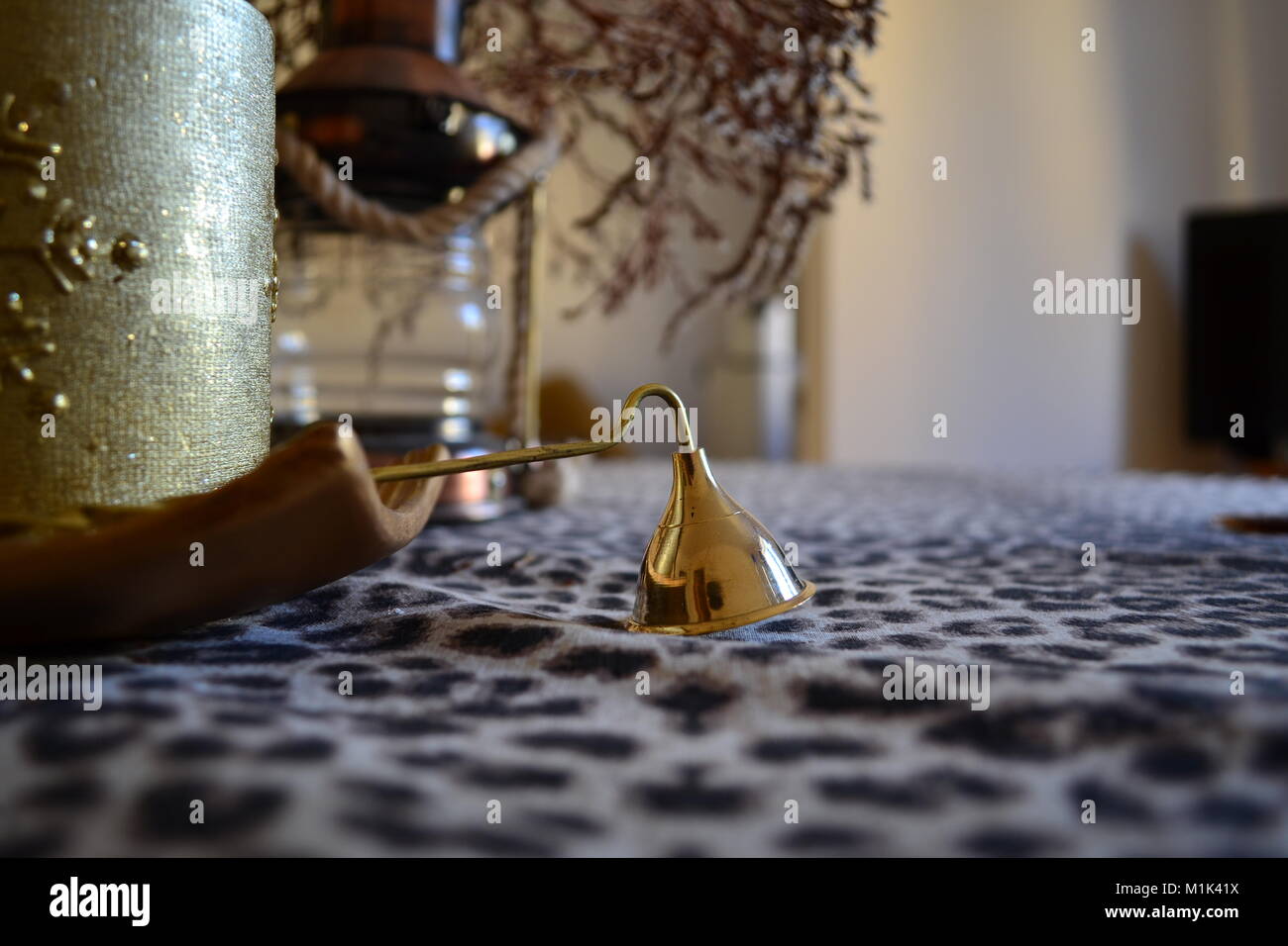 Close-up of a small decorative golden bell indoors Stock Photo - Alamy