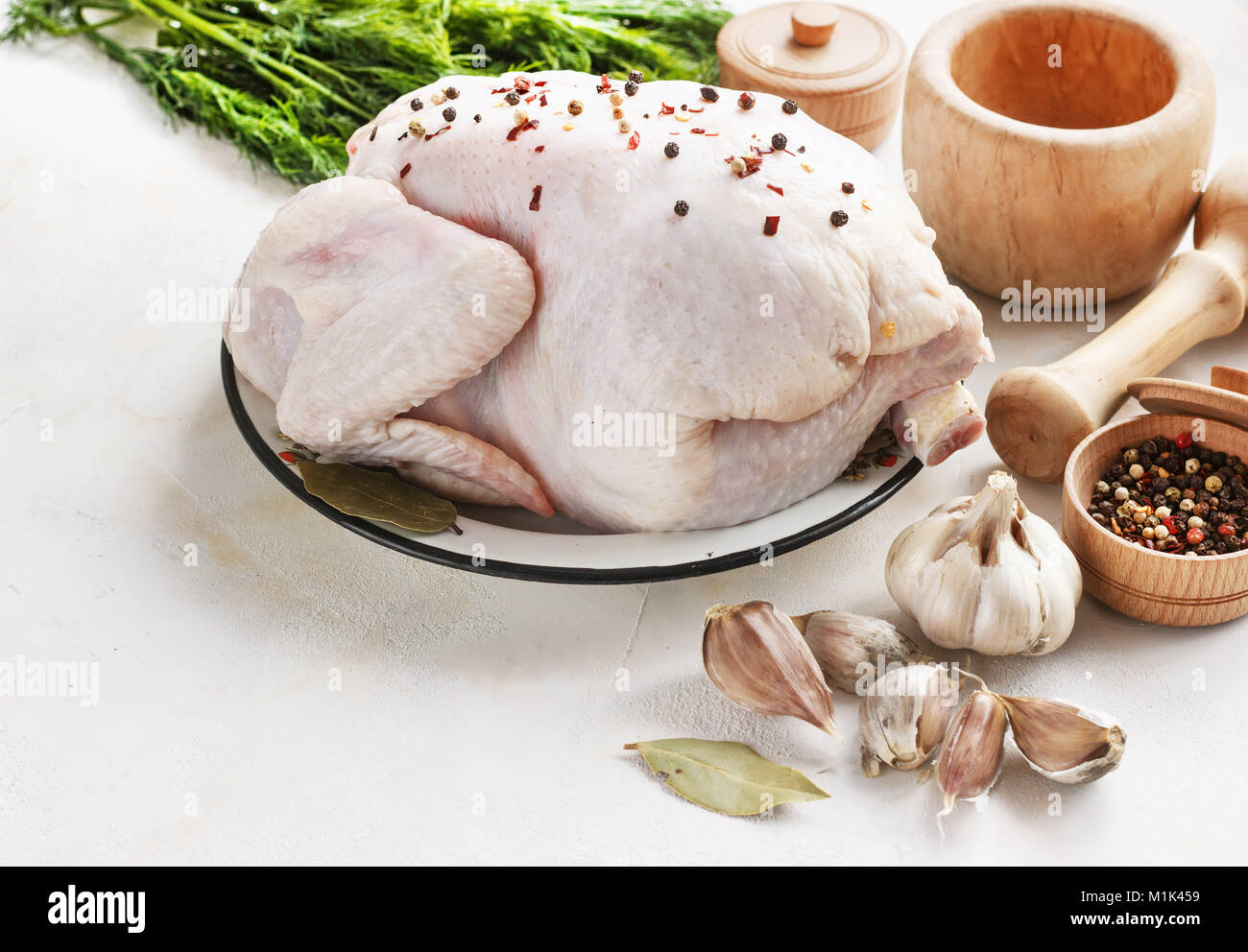 chicken with seasonings on a light background Stock Photo - Alamy