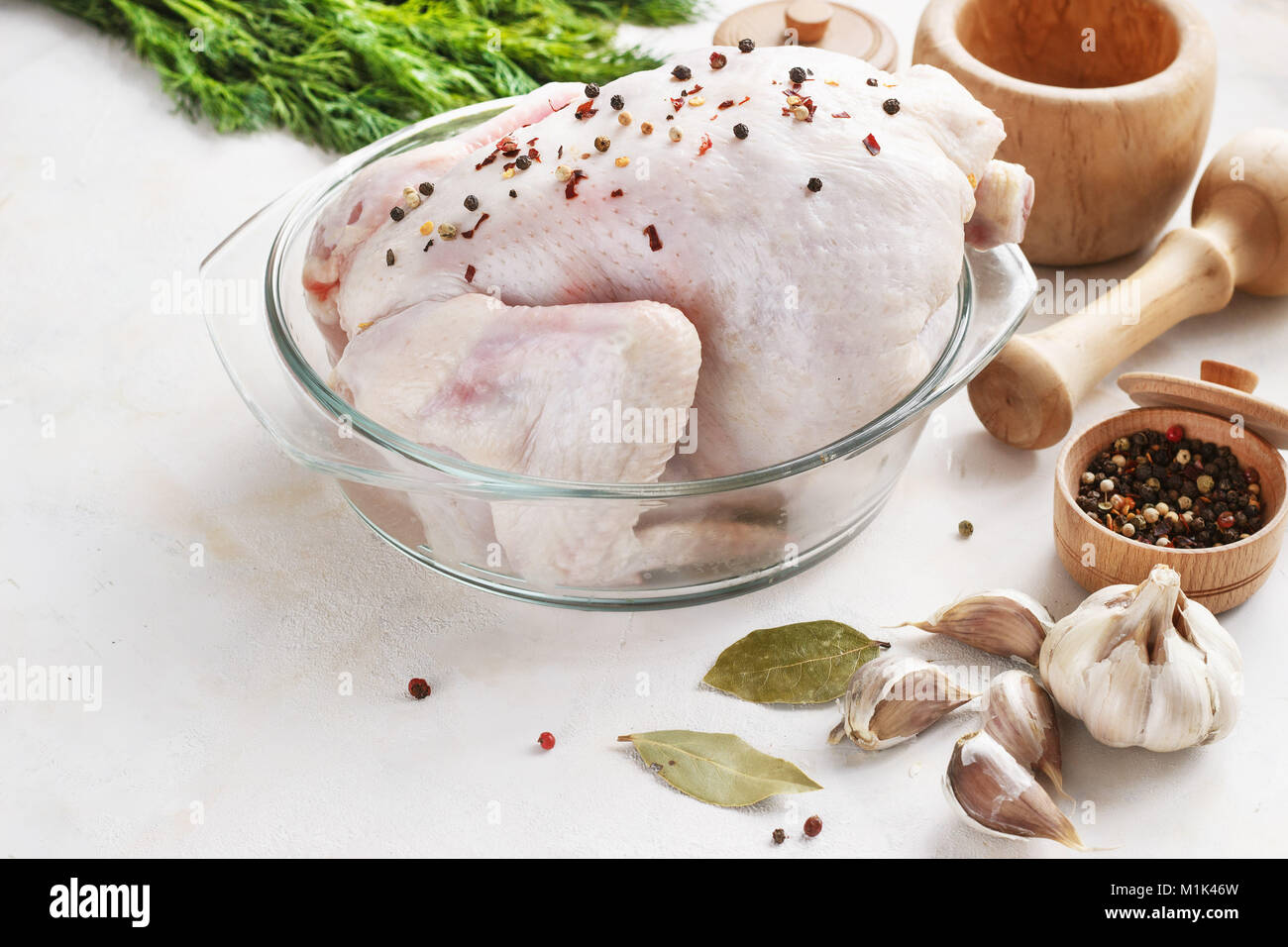 chicken with seasonings on a light background Stock Photo - Alamy