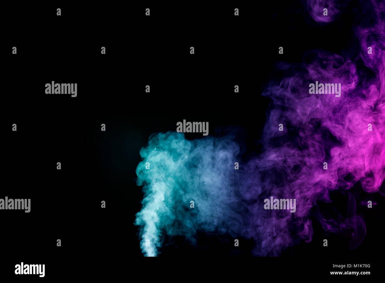 Dense multicolored smoke of red and blue colors on a black isolated ...