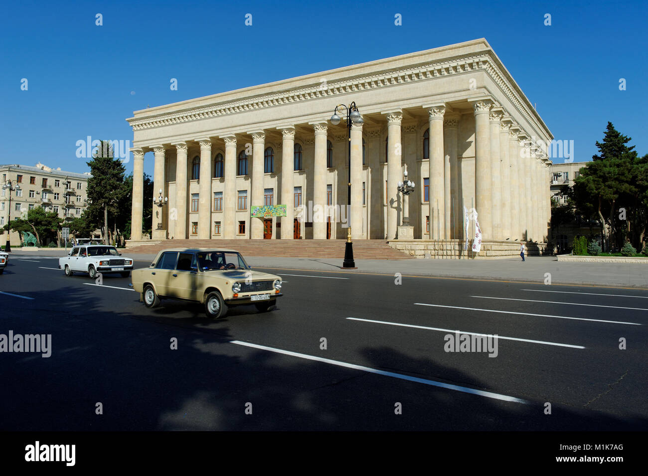 Distinctive Lada cars drive past the Museum Centre (the former Lenin ...