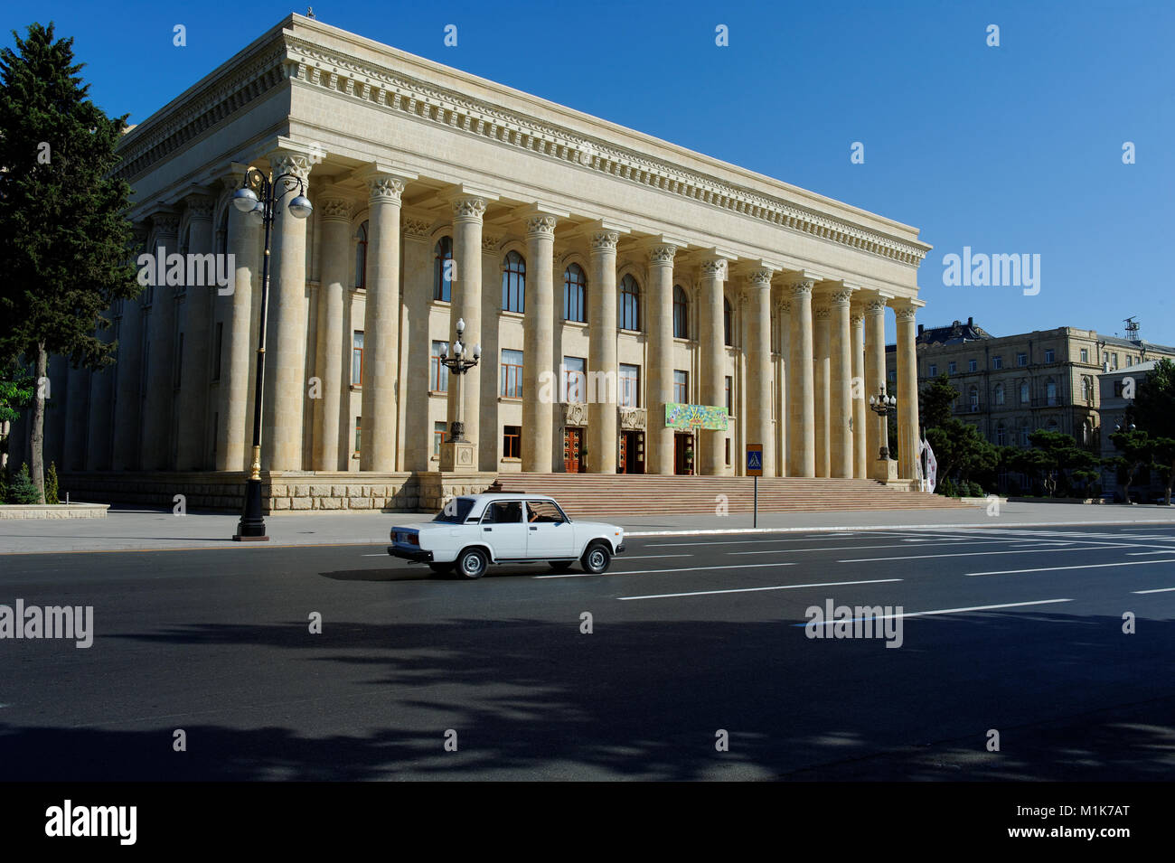 Distinctive Lada cars drive past the Museum Centre (the former Lenin ...