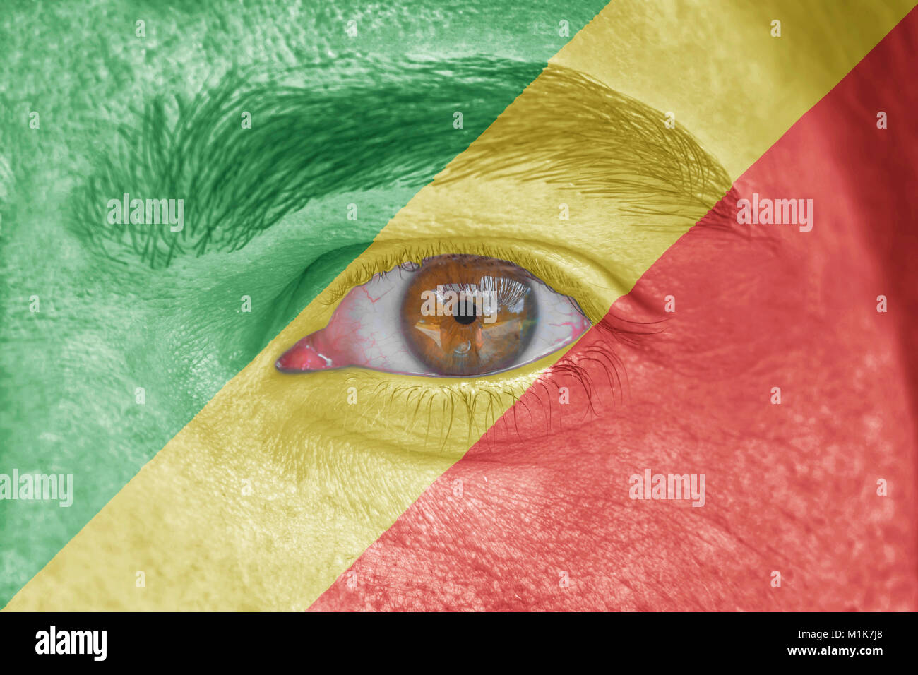 Human face and eye painted with flag of Congo Republic Stock Photo - Alamy