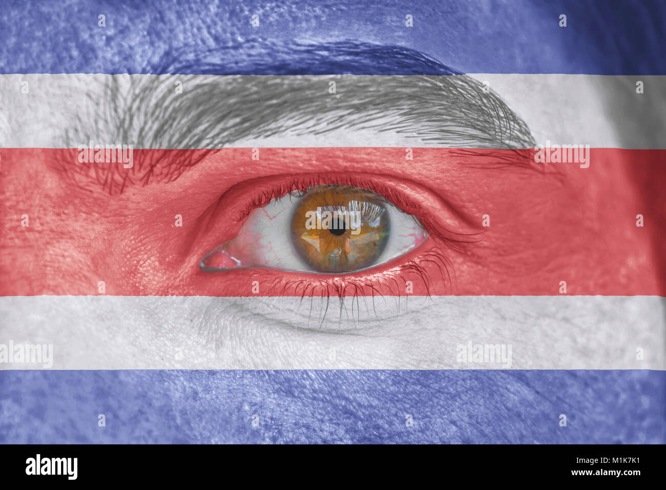 Human face and eye painted with flag of Costa Rica Stock Photo - Alamy