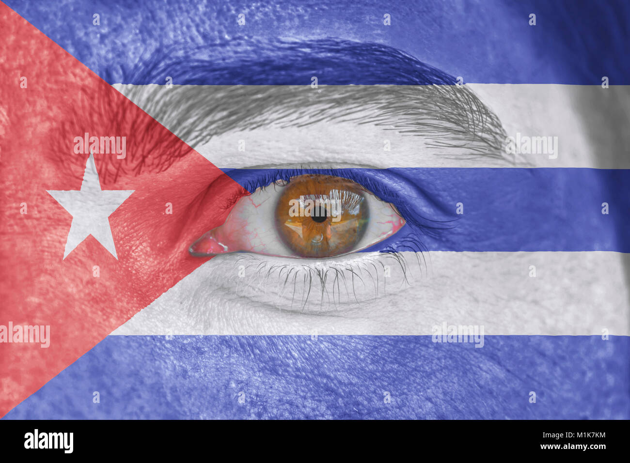 Human face and eye painted with flag of Cuba Stock Photo - Alamy
