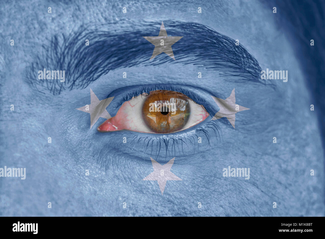 Human face and eye painted with flag of Federate State Of Micronesia ...