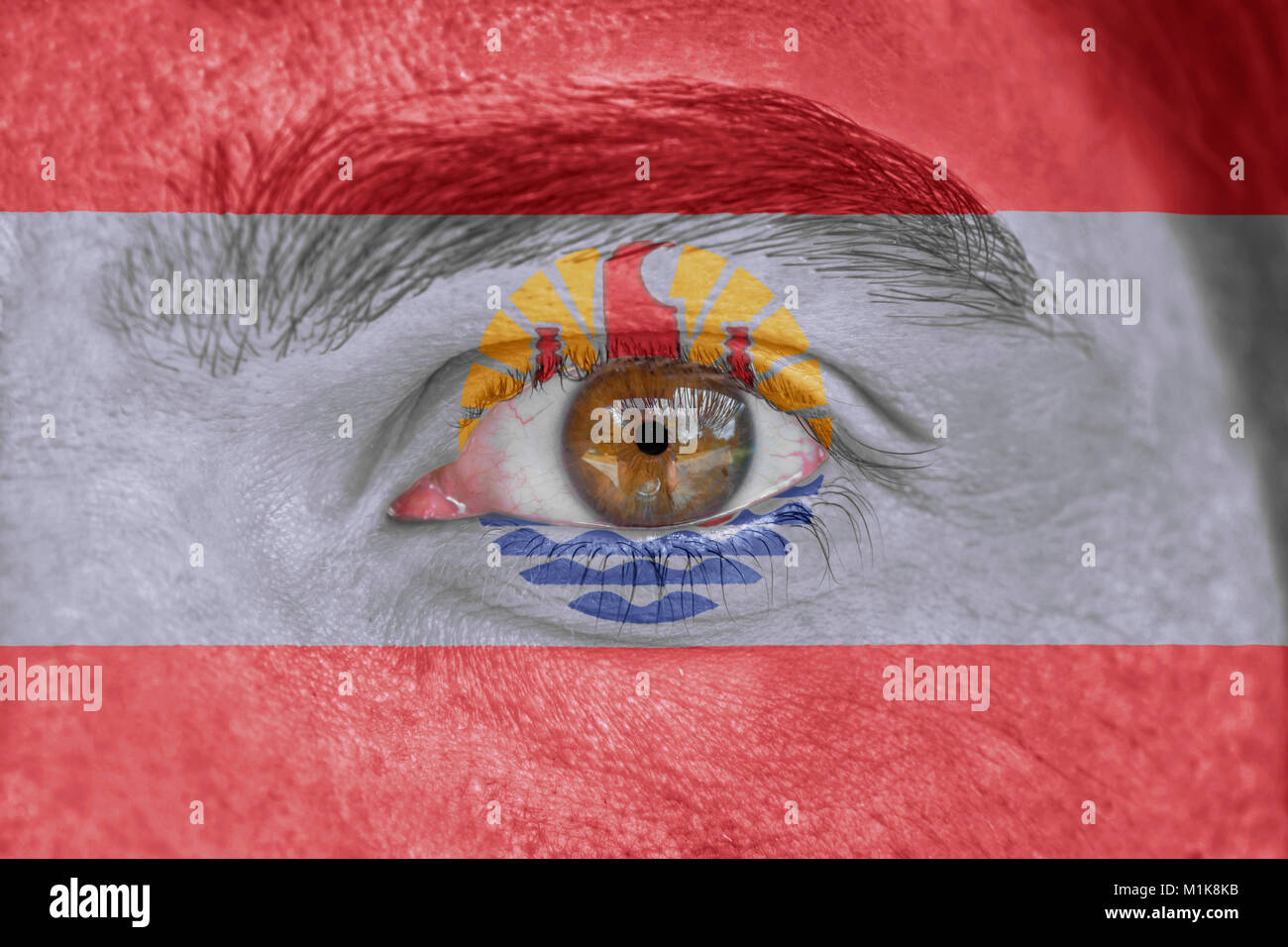 Human face and eye painted with flag of French Polynesia Stock Photo ...