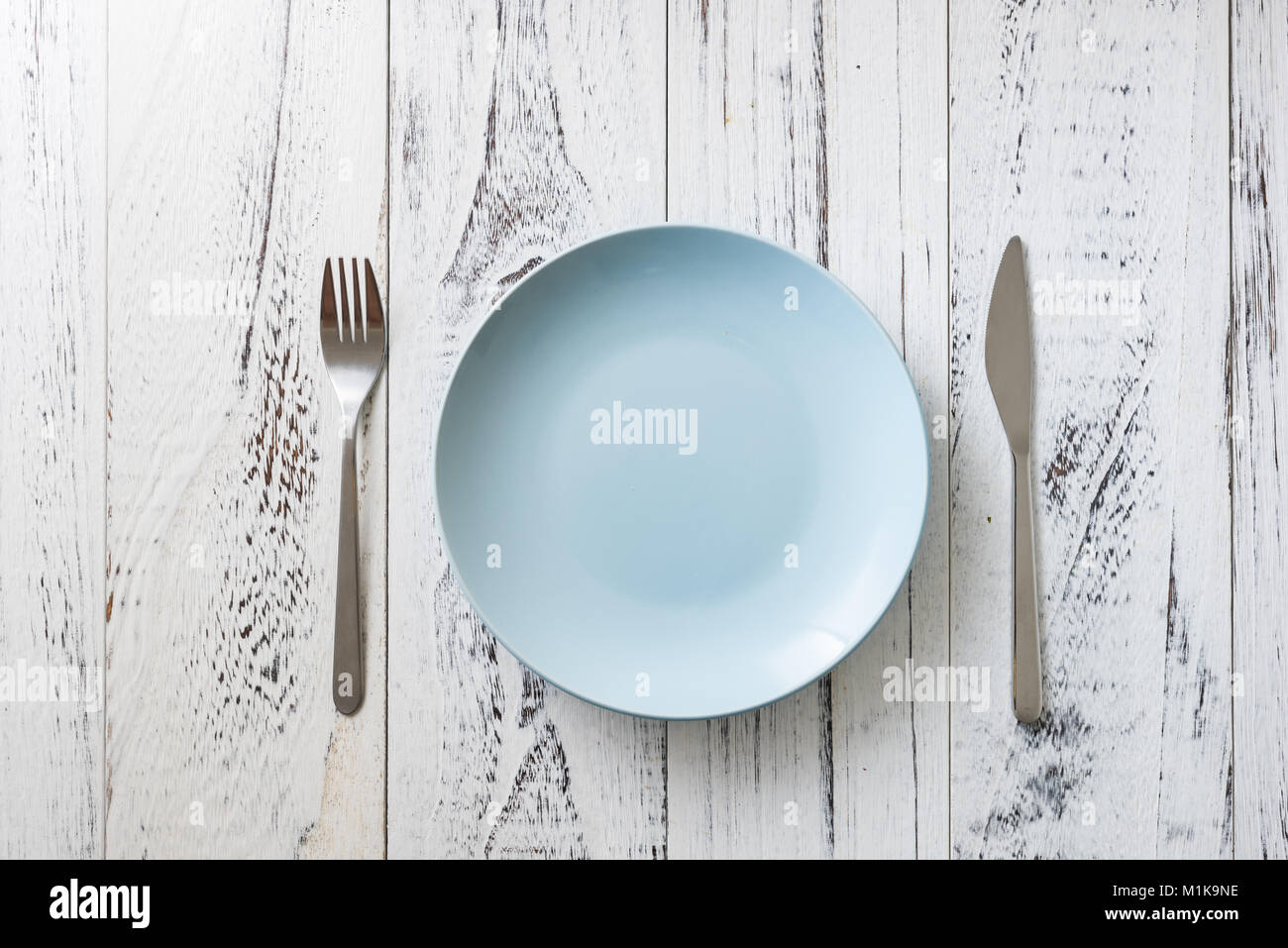 Blue Round Plate with utensils on white wooden table background Stock ...