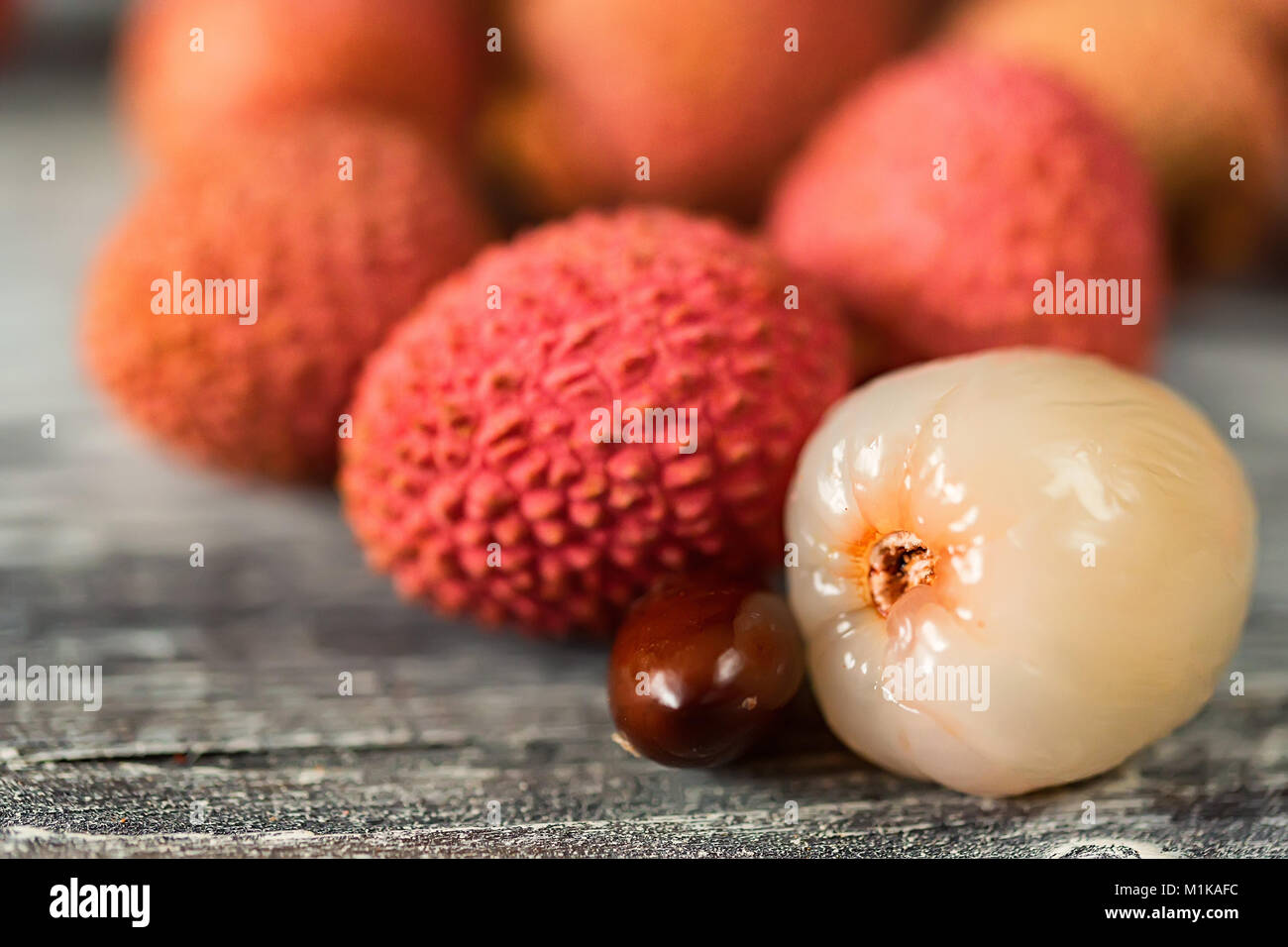 Lychee fruits and seed on wooden background Stock Photo - Alamy