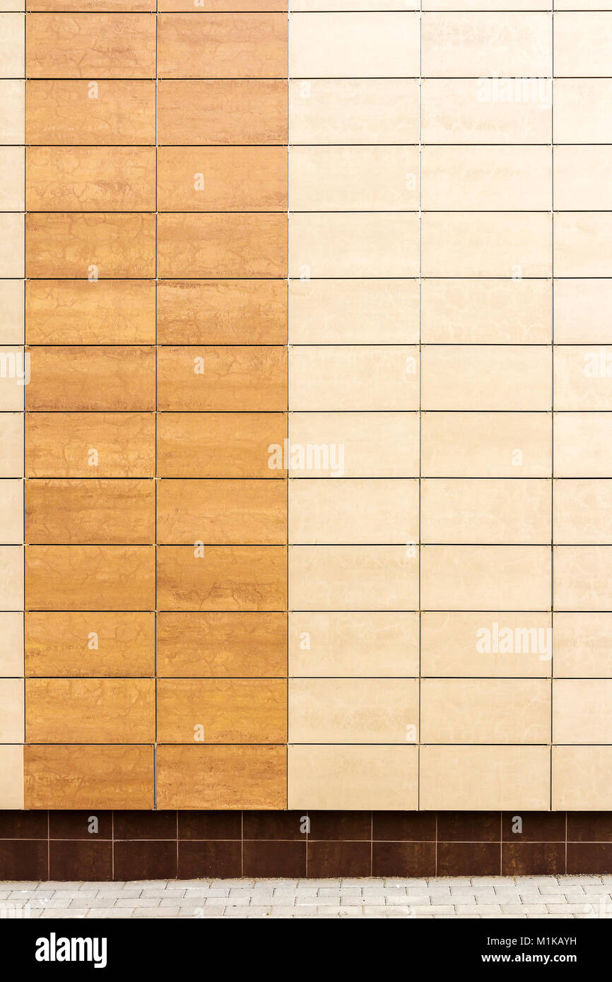 Modern beige metal facade tiles wall and a ground. Abstract ...