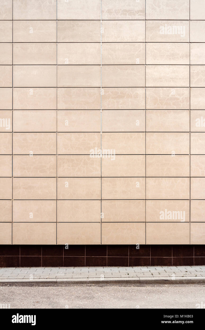 Modern beige metal facade tiles wall and a ground. Abstract ...