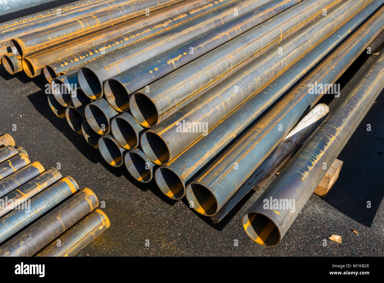 rolled metal pipes stacked Stock Photo - Alamy