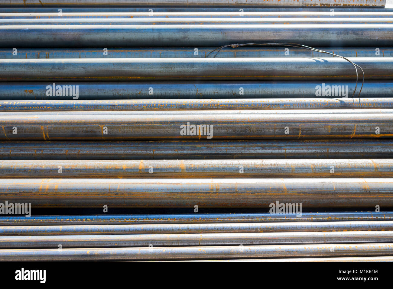rolled metal pipes stacked Stock Photo - Alamy