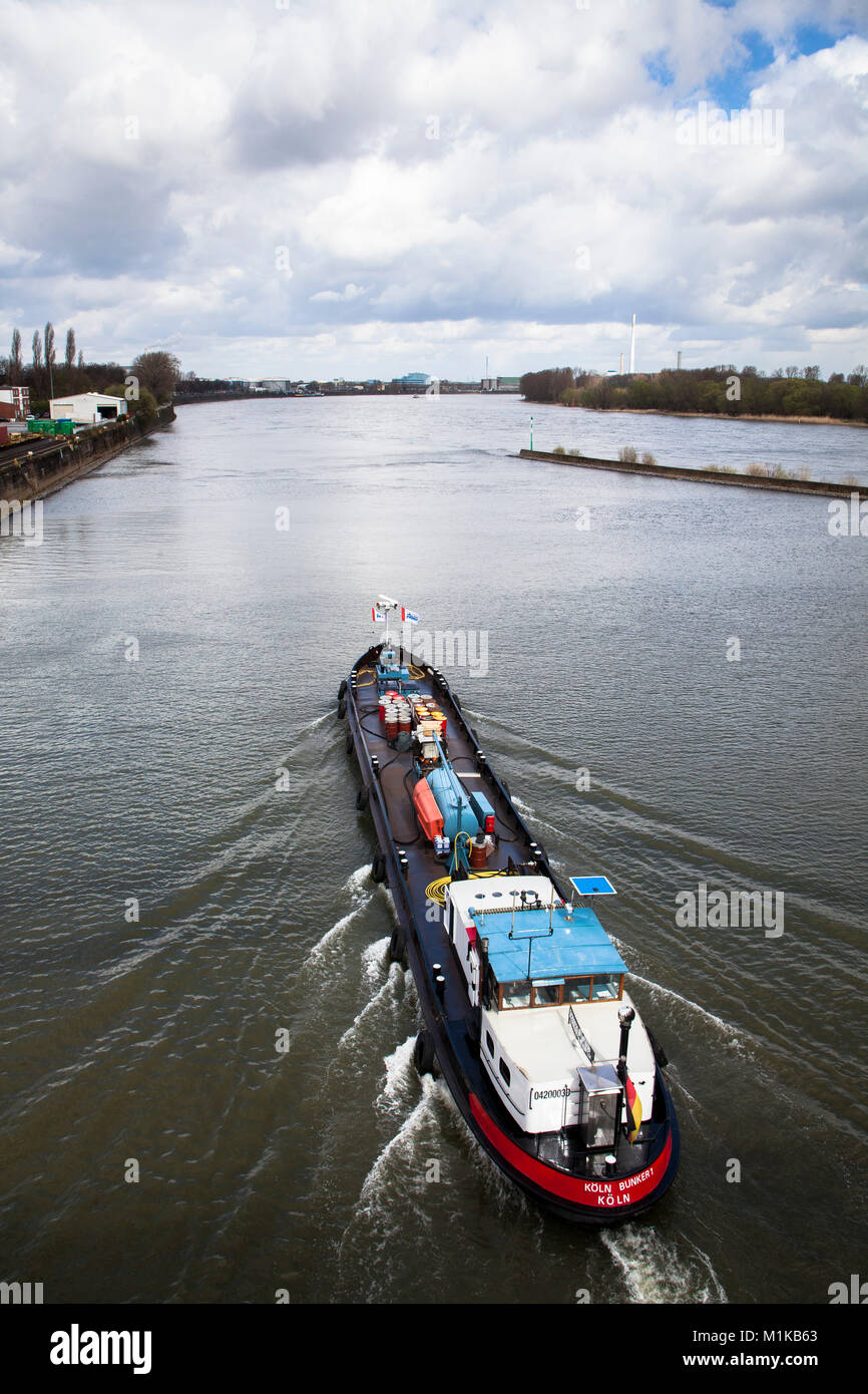 Germany, Cologne, ship leaves the Rhine harbour in the town district ...