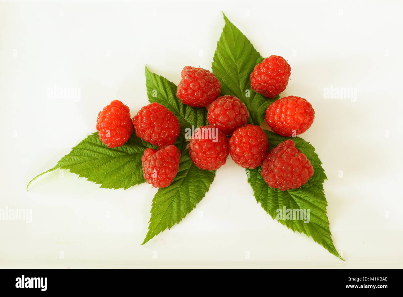 composition of fresh red raspberry fruits isolated on a white ...