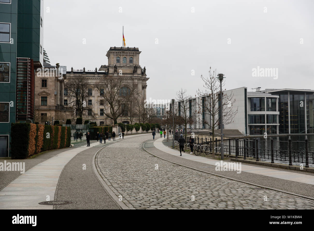 Pedestrianized street in Berlin along the river Spree leading to German ...
