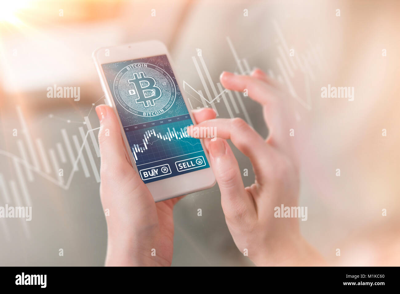 Bitcoin symbol on mobile app screen with big BUY and SELL buttons ...