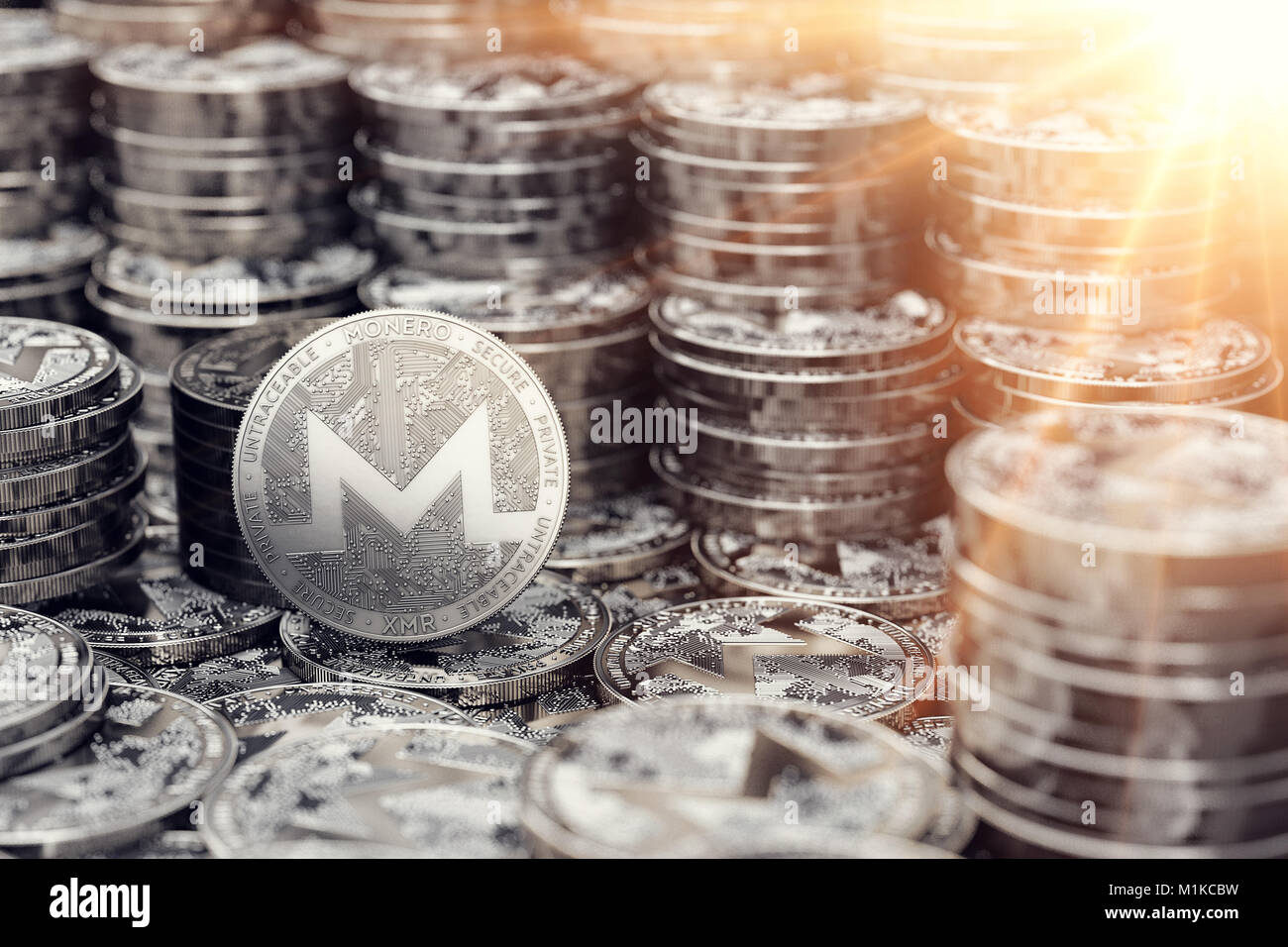 Silver Monero coin on the left and piles of coins. Bright sun flare as ...