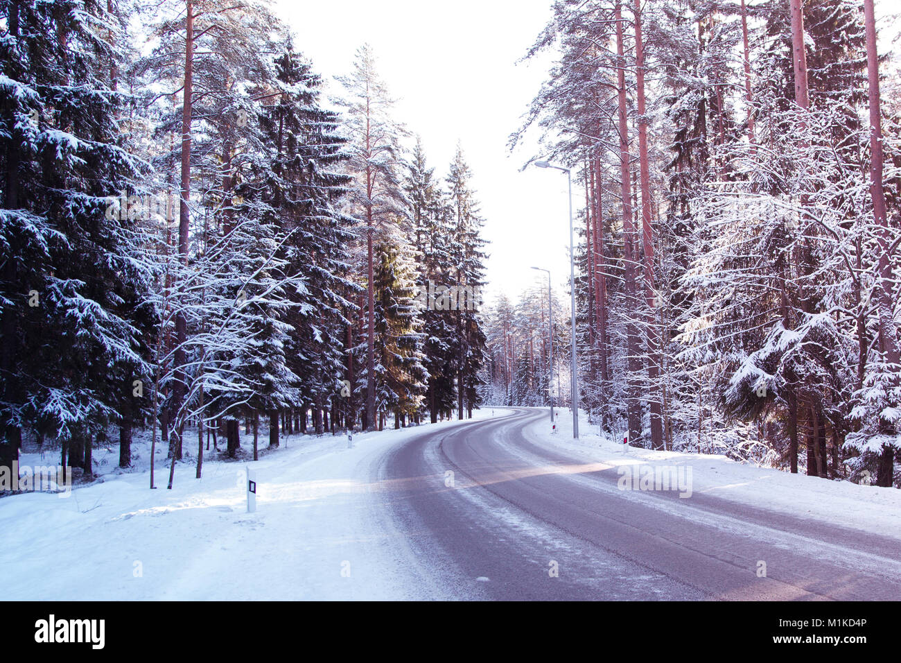 Asphalt road through snow hi-res stock photography and images - Alamy