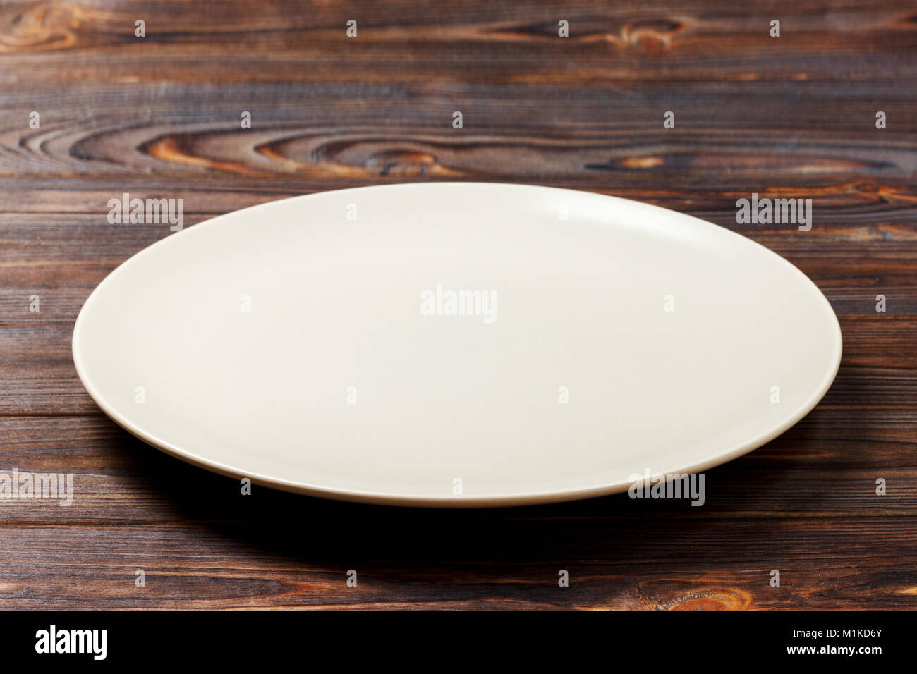 empty round plate for food on wood bachground. Perspective view Stock ...