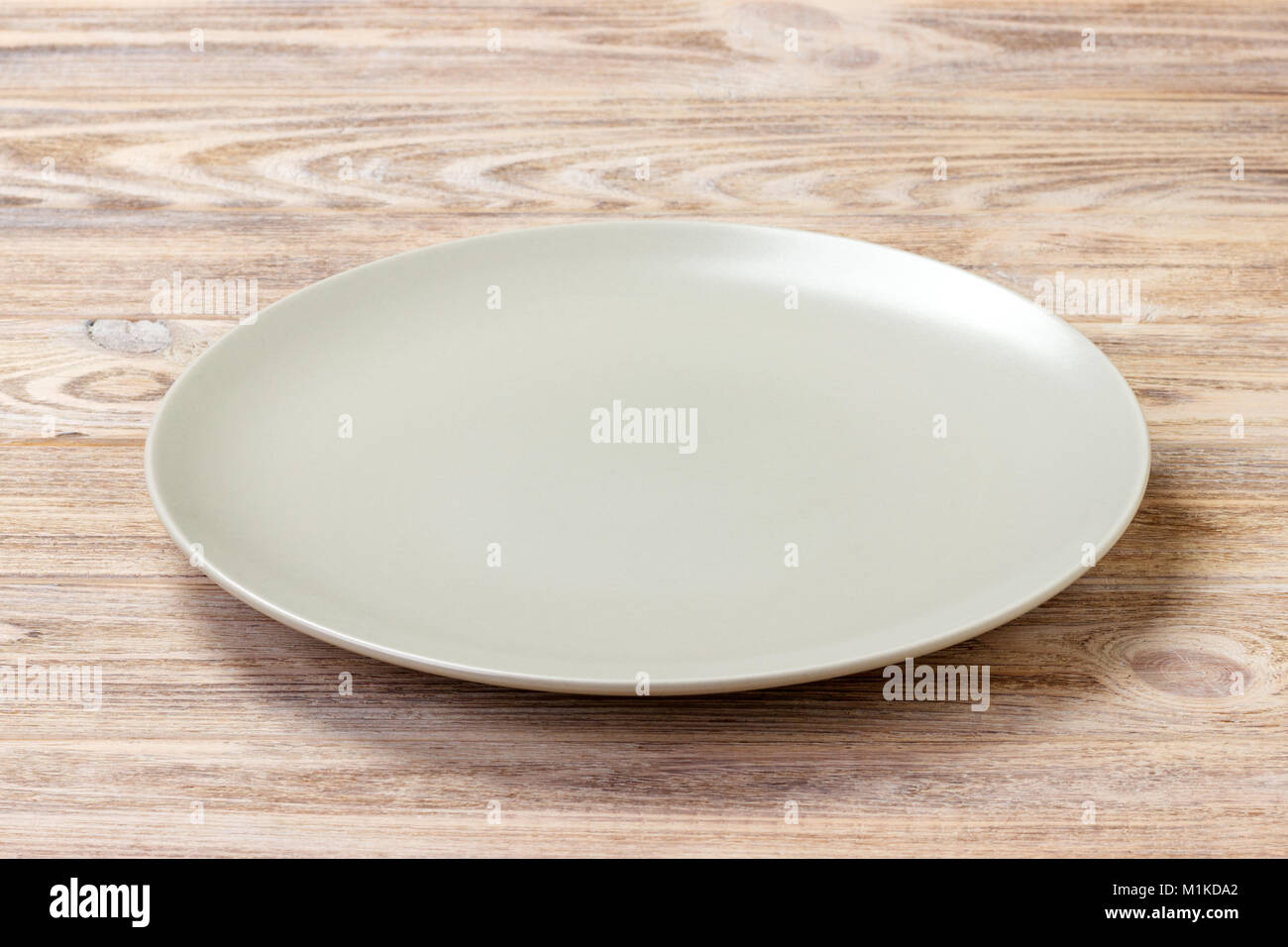 empty round plate for food on wood bachground. Perspective view Stock ...