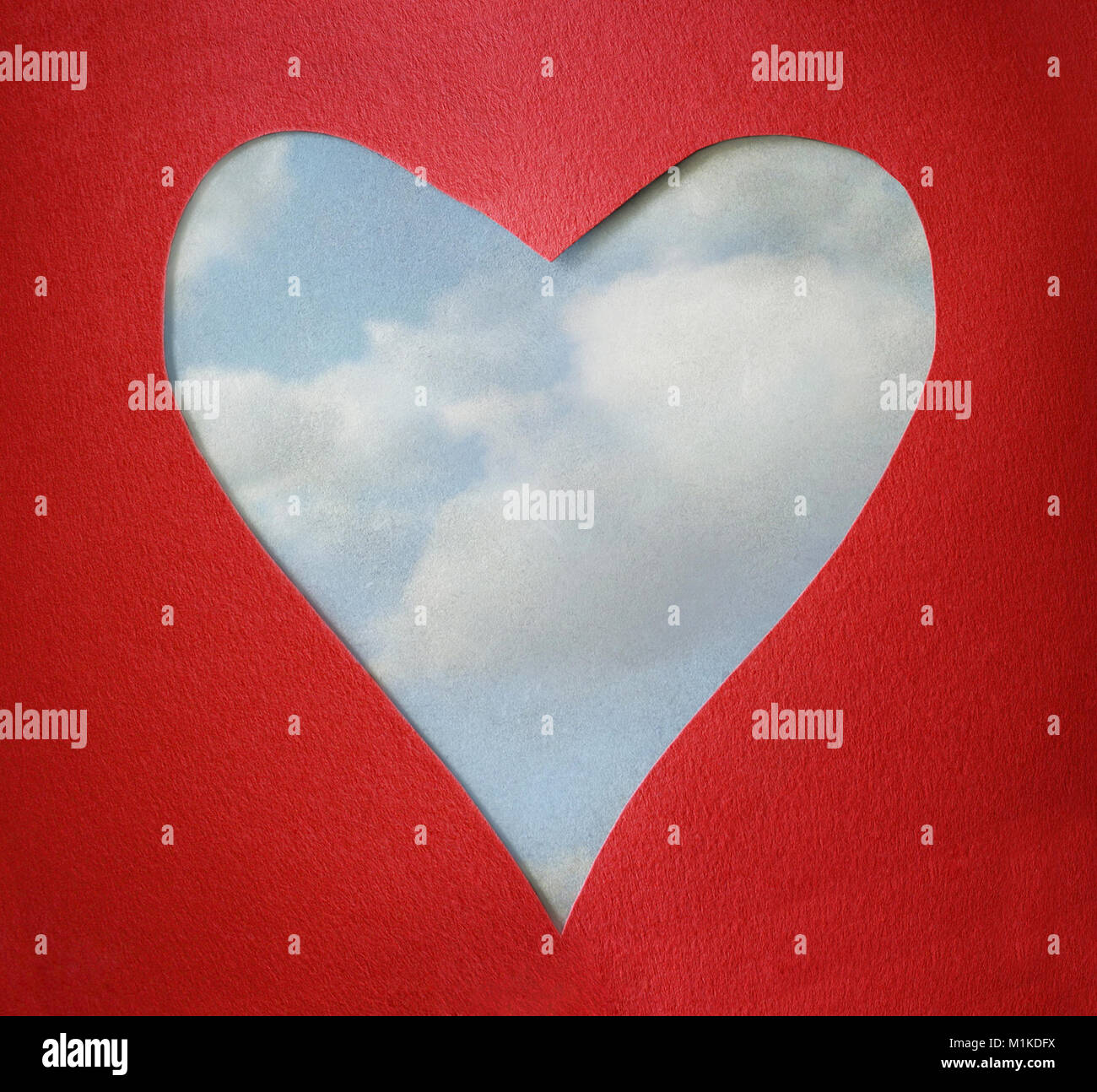 A big red heart shape cutout of cardboard with the sky and clouds Stock ...