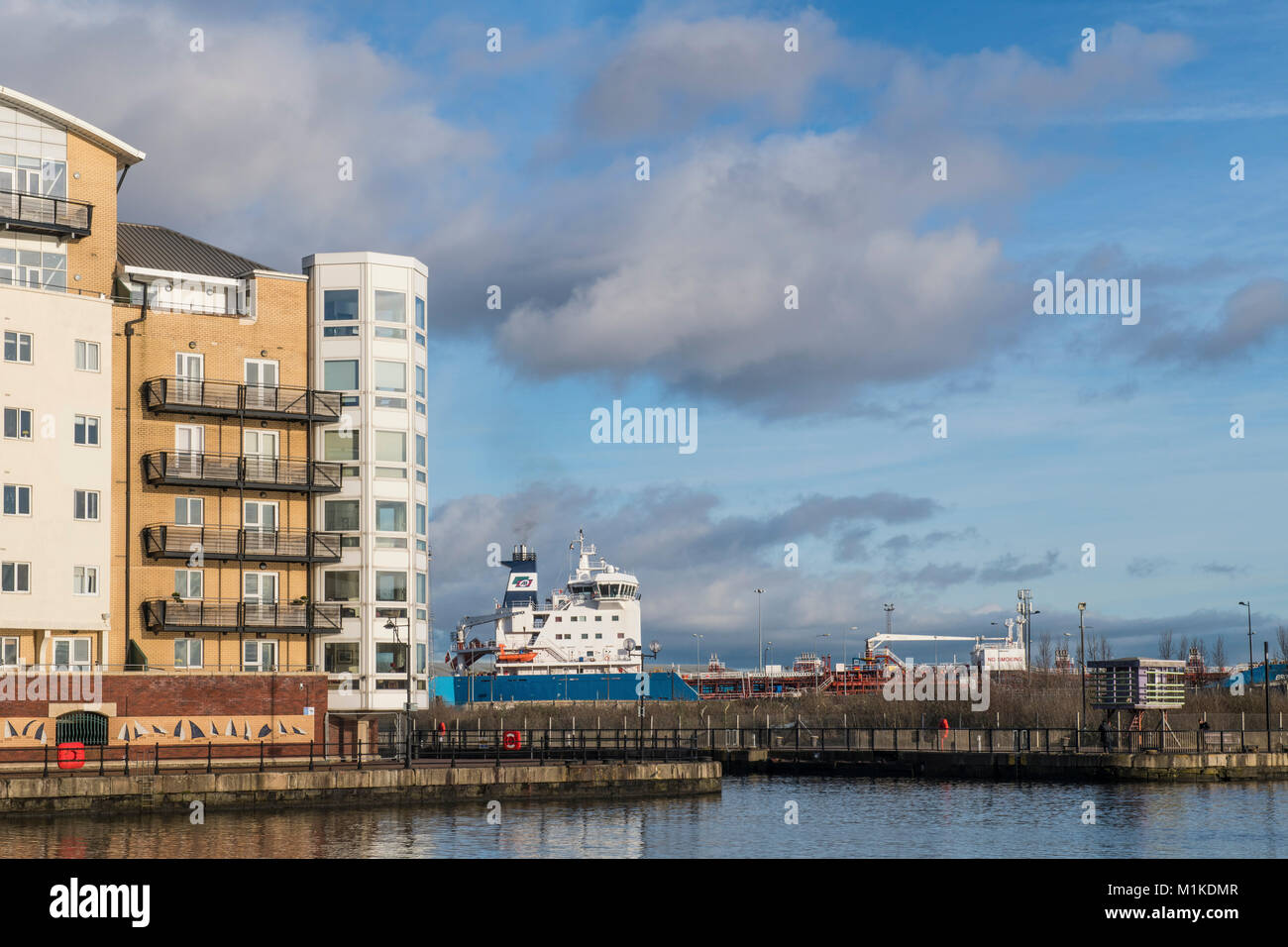 The regenerated Cardiff Bay with an apartment block and a large tanker ...
