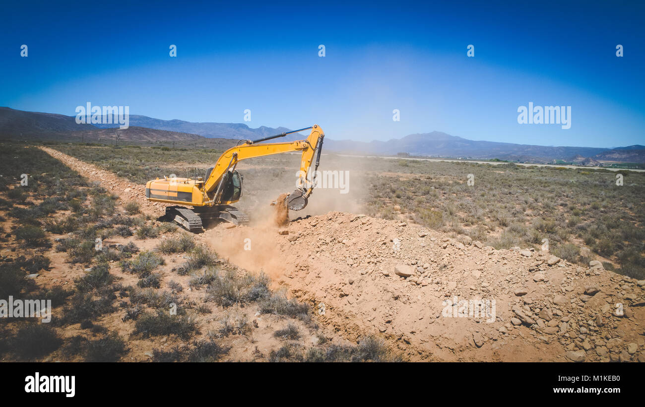 Aerial photo of earth moving machinery front loader digging a trench on ...