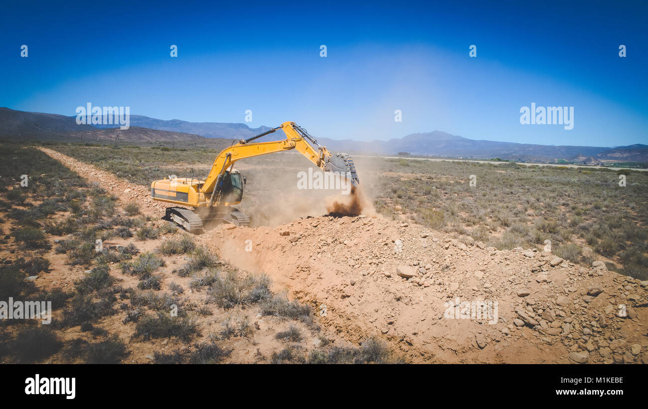 Aerial photo of earth moving machinery front loader digging a trench on ...