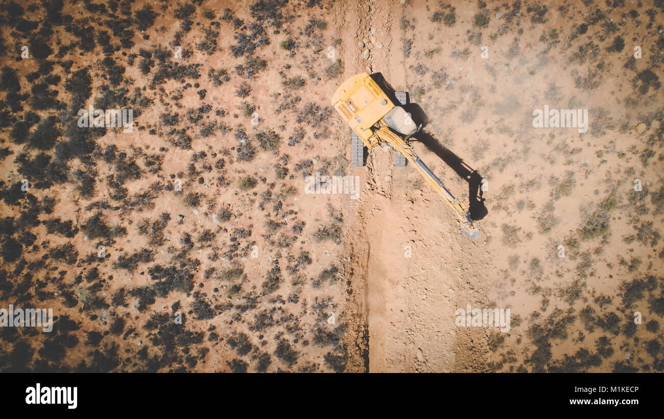 Aerial photo of earth moving machinery front loader digging a trench on ...