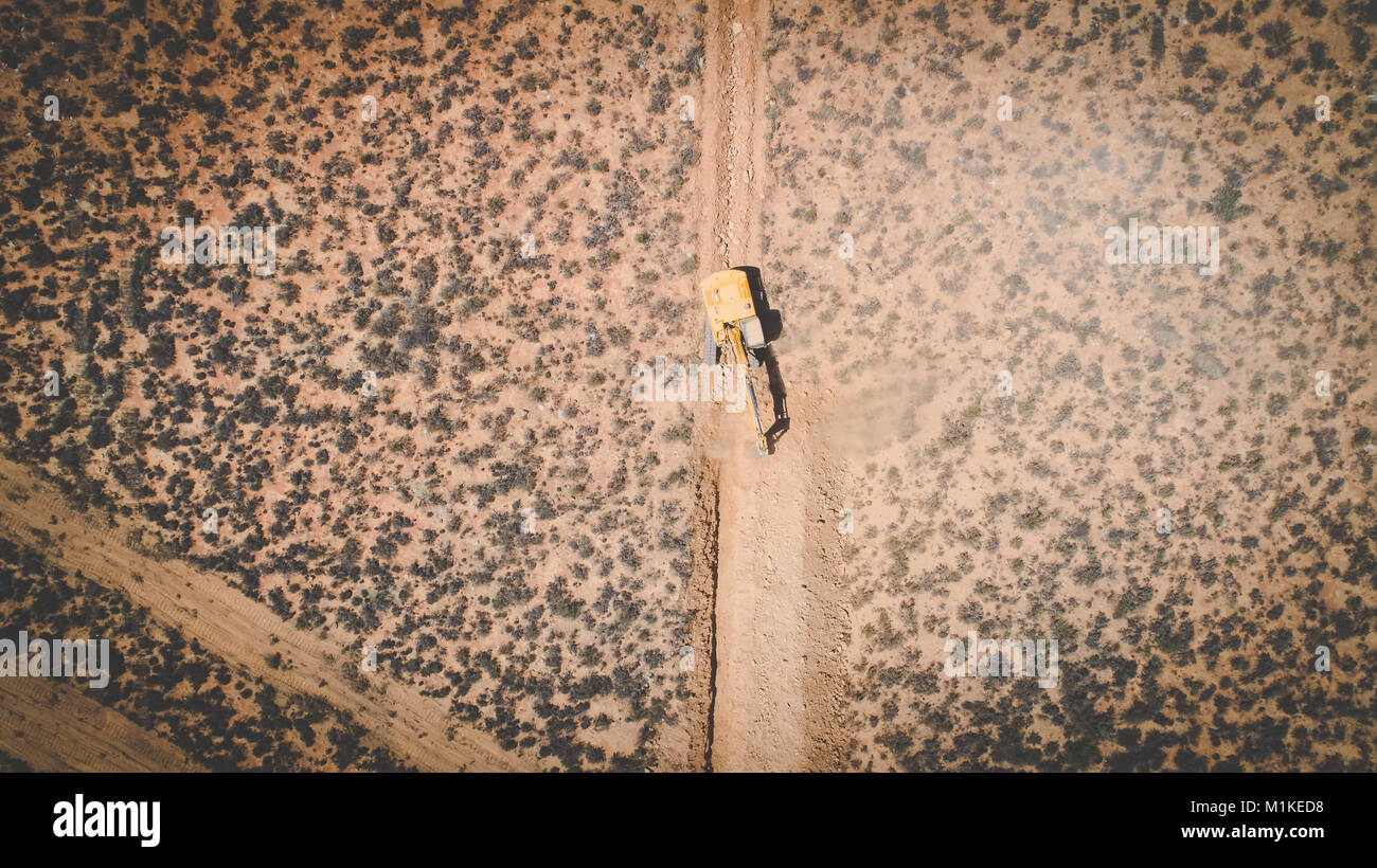 Aerial photo of earth moving machinery front loader digging a trench on ...