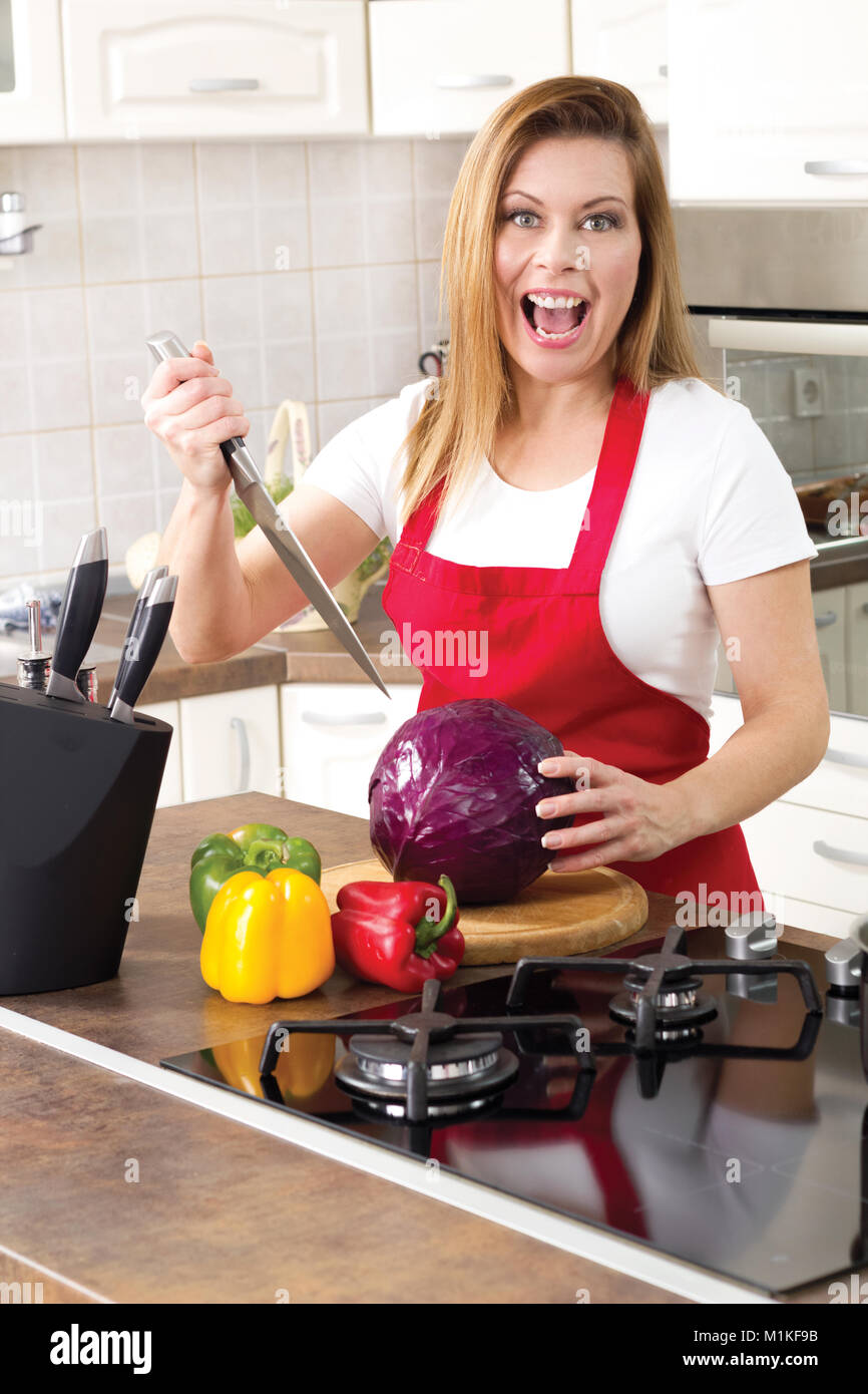 Hand holding knife cutting vegetables hi-res stock photography and ...