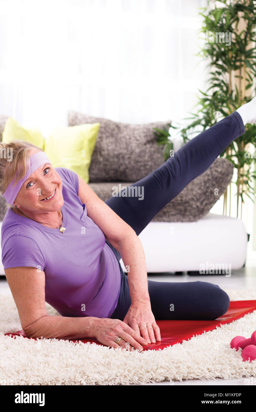 Older women Stretches legs and smiling at home Stock Photo - Alamy