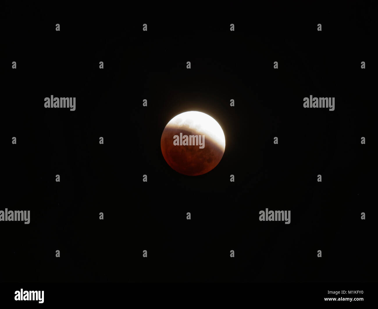 Super blue blood moon with partial lunar eclipse over dark sky ...
