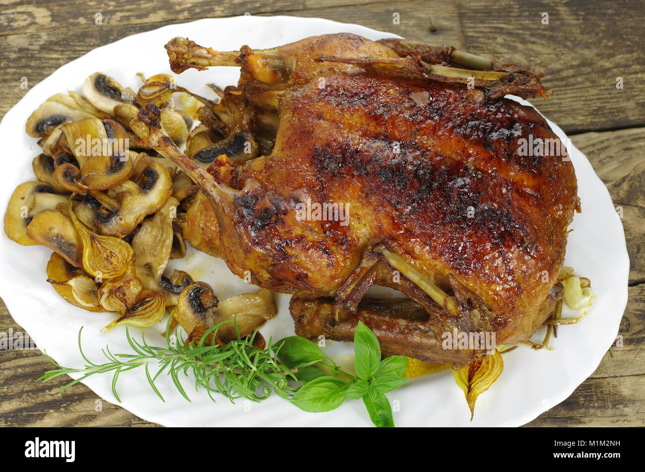 whole roast honey duck on white plate Stock Photo - Alamy