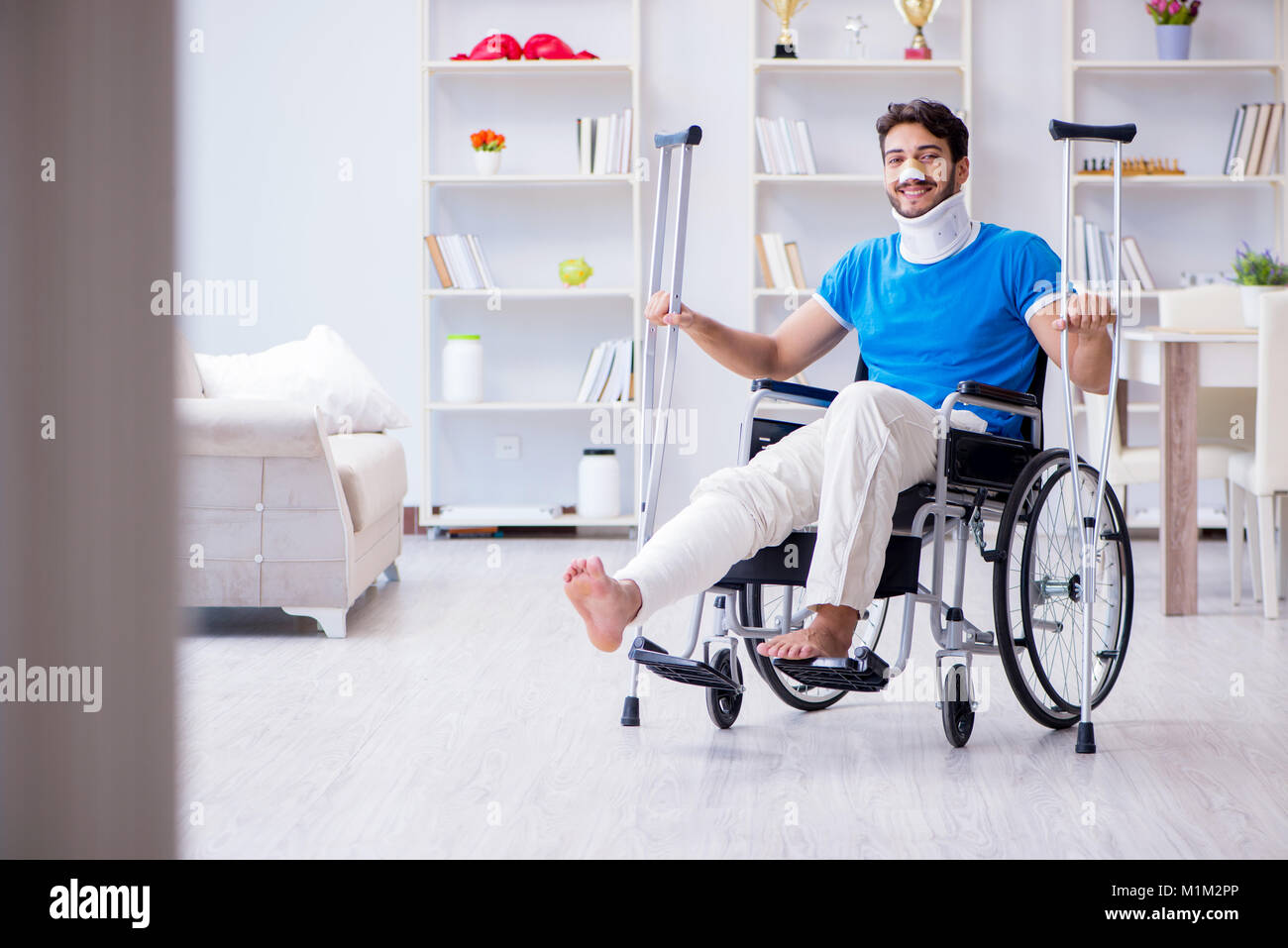Injured young man recovering at home Stock Photo - Alamy